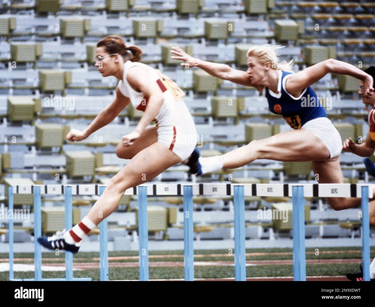 Heide Rosendahl of West Germany, left, clears a hurdle in the 100 meter ...