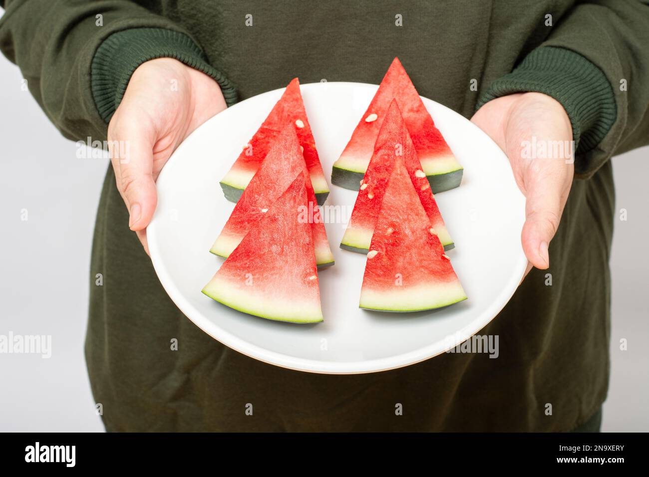 Hand holding fresh watermelon slice hi-res stock photography and images ...