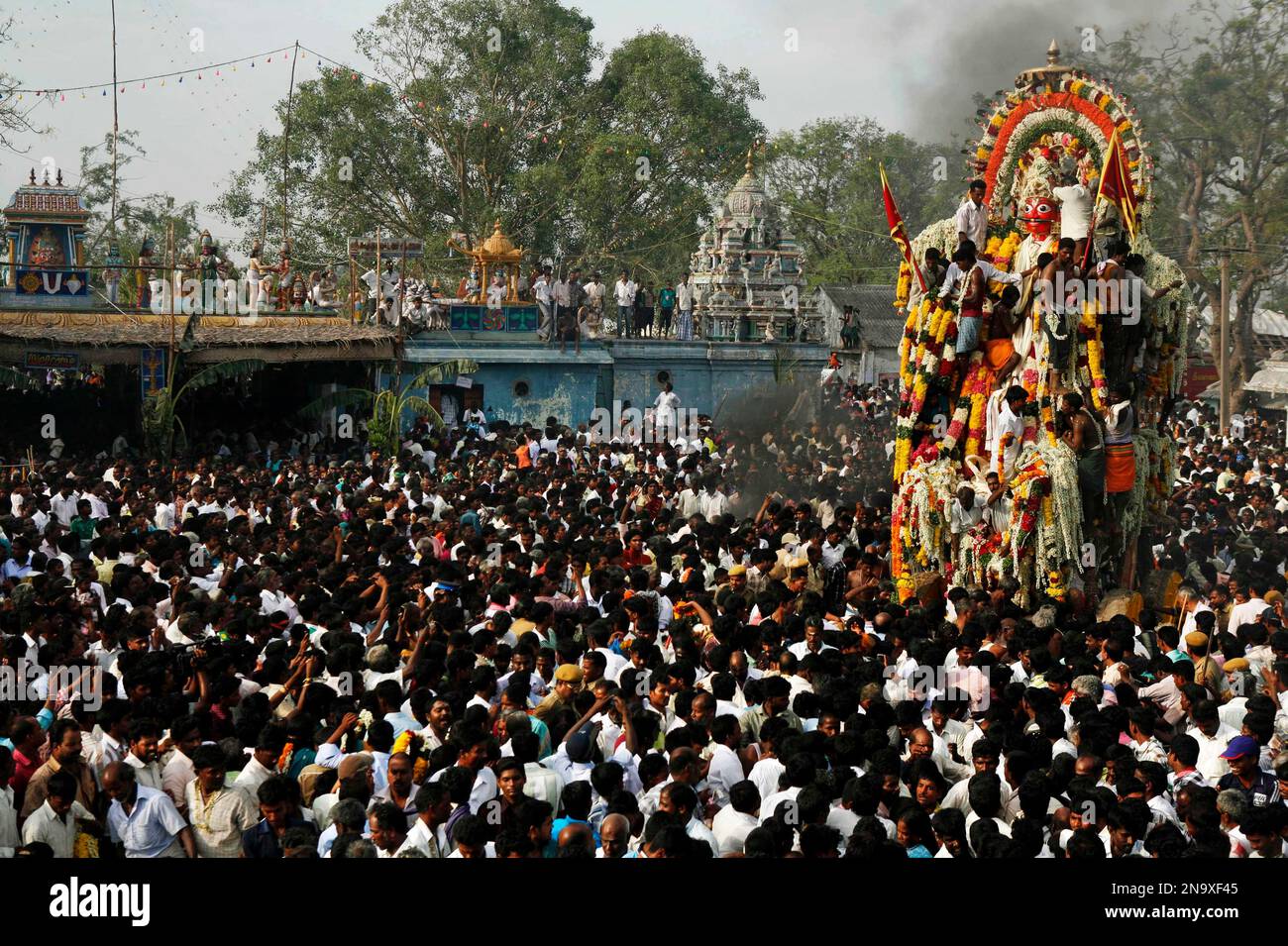 An idol of warrior god Aravan is taken in a chariot during the annual ...