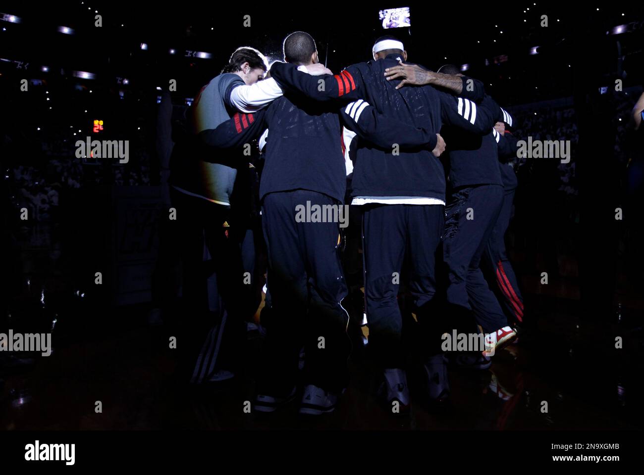 Miami Heat's LeBron James, center, huddles with his teammates before an ...