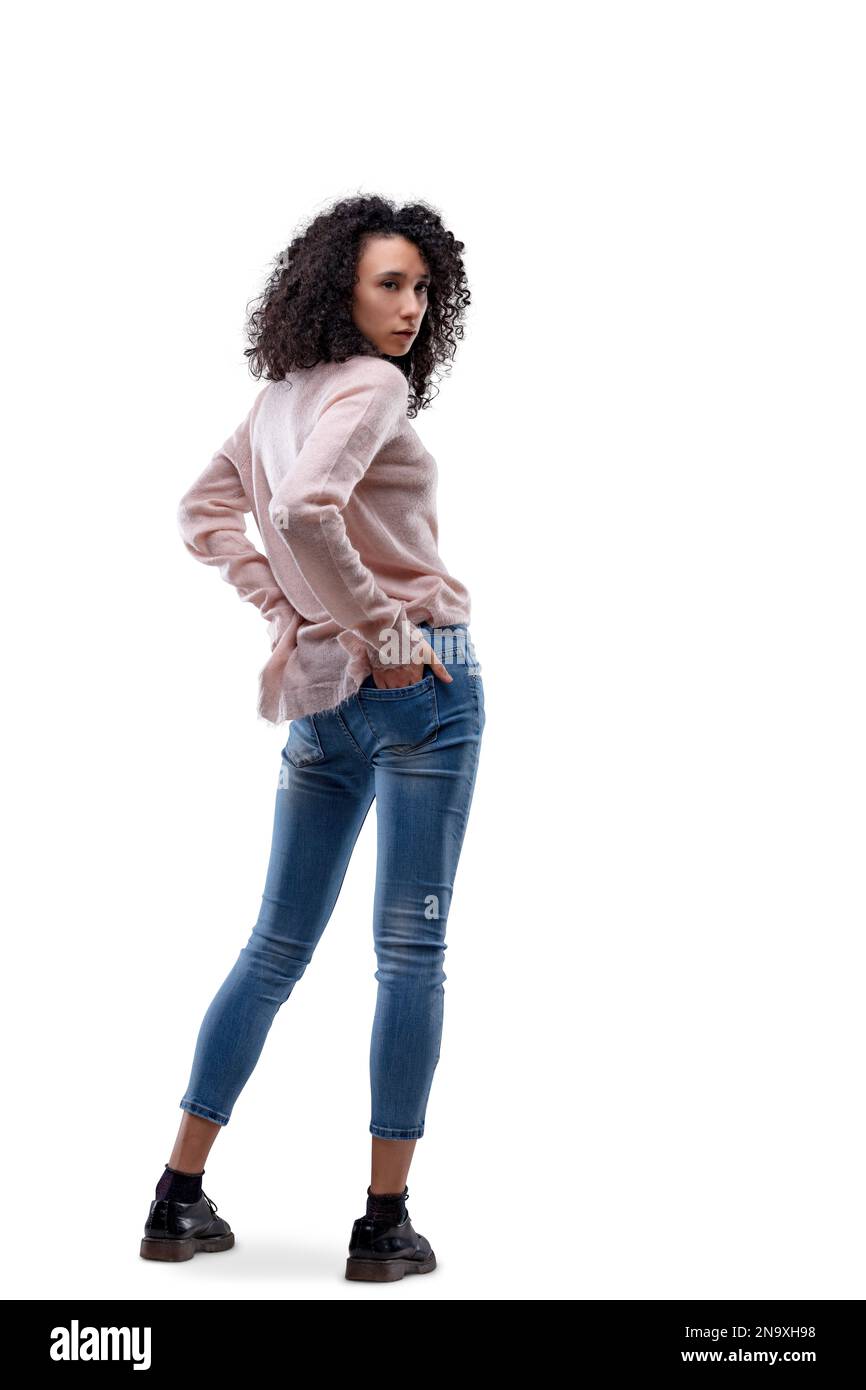 Young woman seen from behind, wearing jeans and pink sweater, full ...