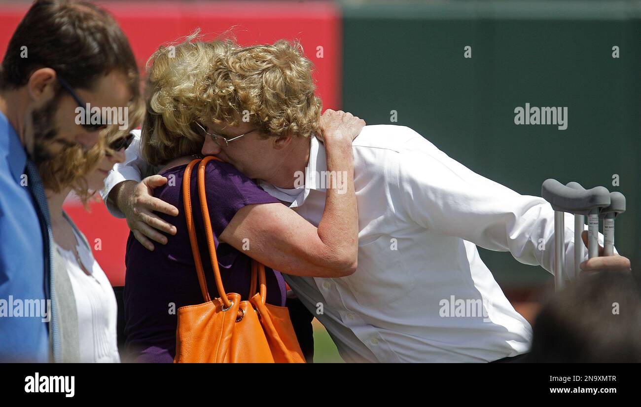 Anne Anderson, mother of Alexis Busch, is embraced by Busch's boyfriend ...