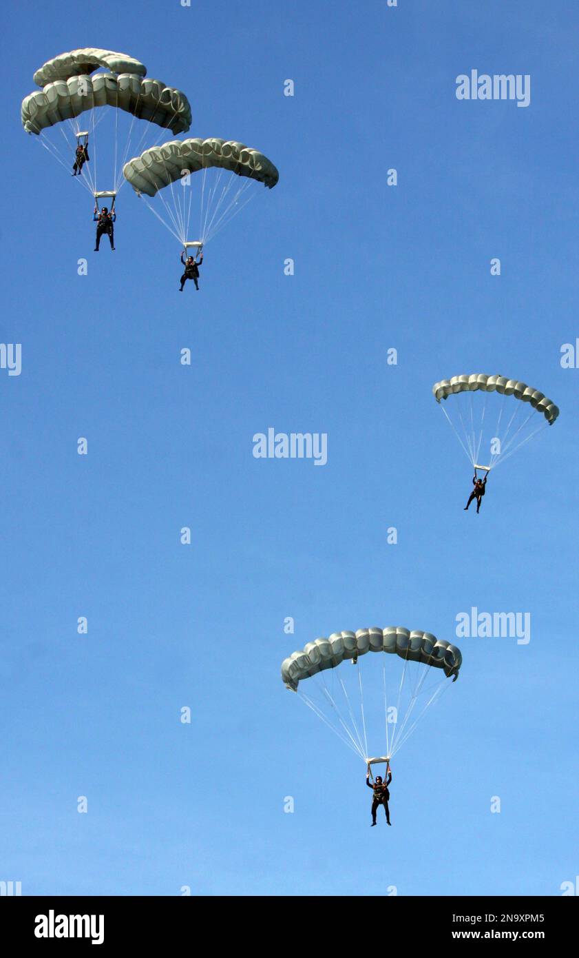 Indonesian military special force personnel parachute down during a ...