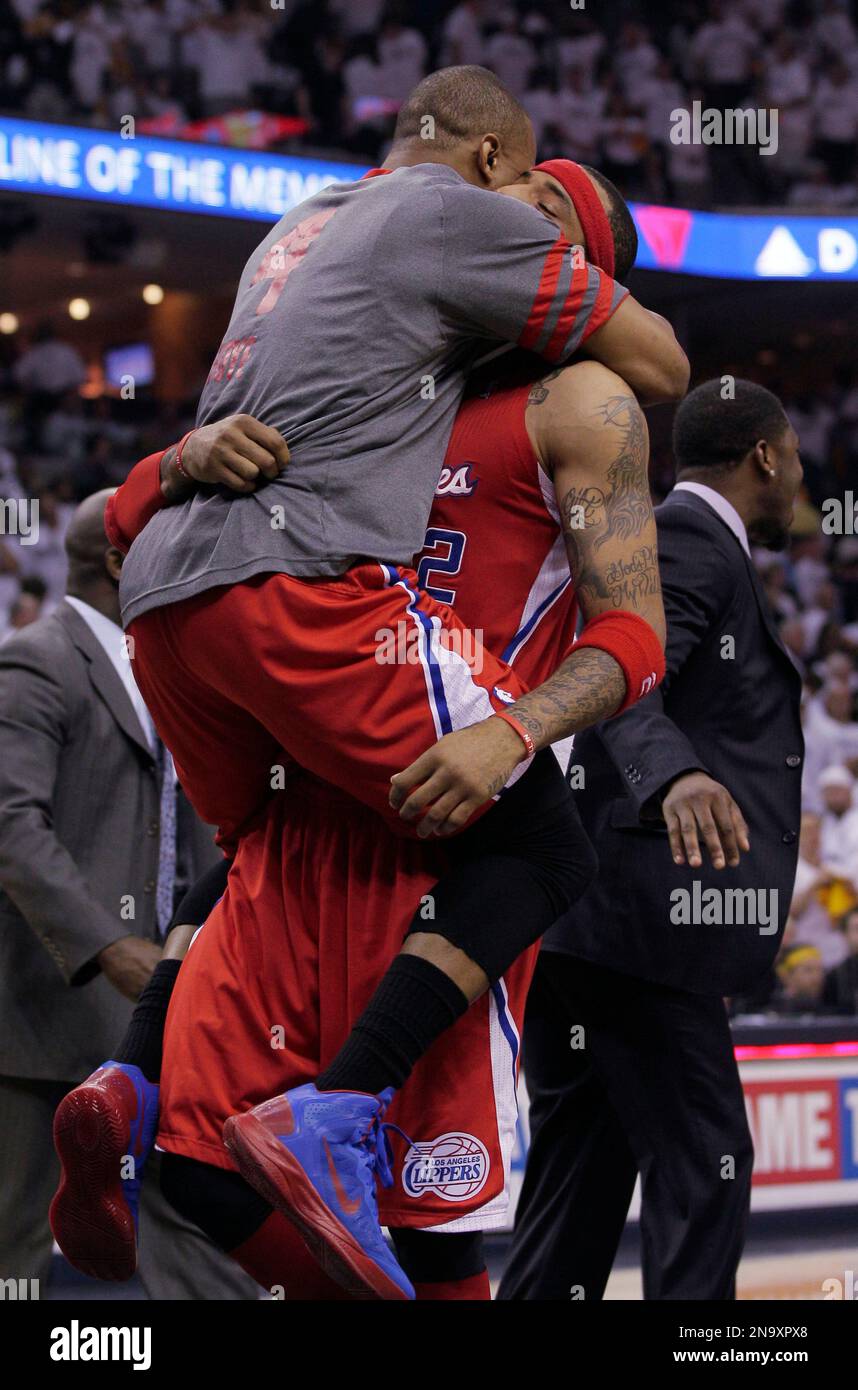 Los Angeles Clippers' Randy Foye, left, jumps on teammate Kenyon Martin ...