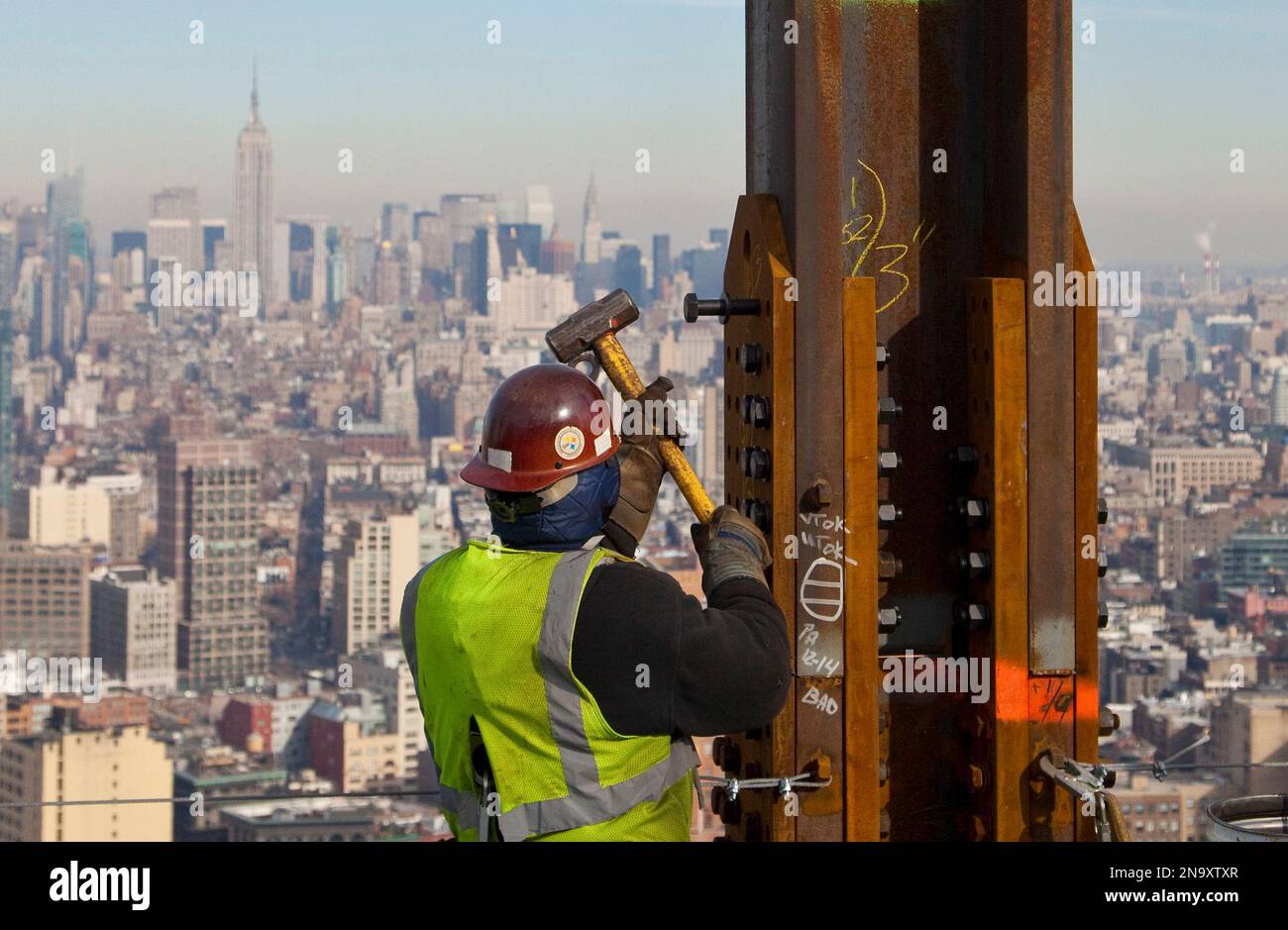 FILE- In this Dec. 16, 2010, file photo, an ironworker connects a steel ...