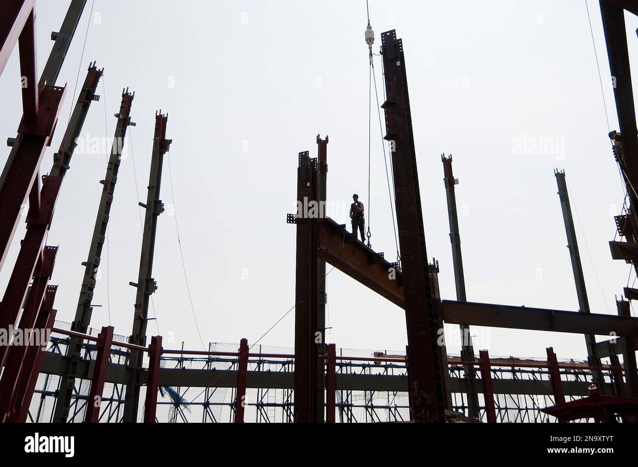 In this March 23, 2012, photo, an ironworker walks a steel beam at the ...