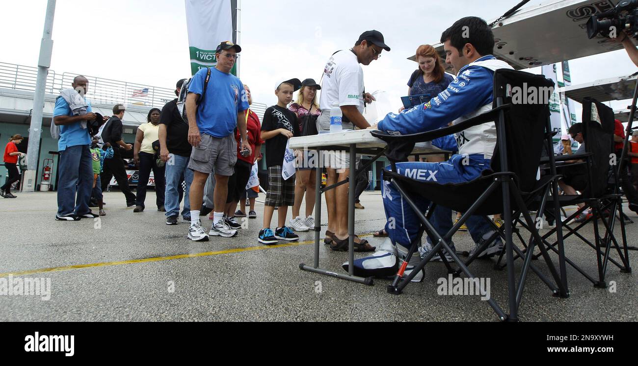 Driver Memo Rojas, of Mexico City, signs autographs for fans during the ...