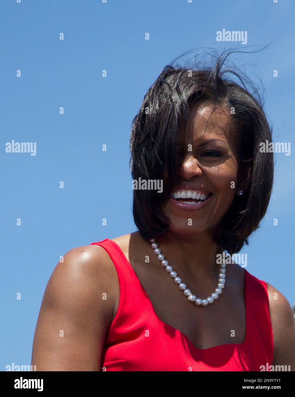 First Lady Michelle Obama smiles to the crowd as she and President ...