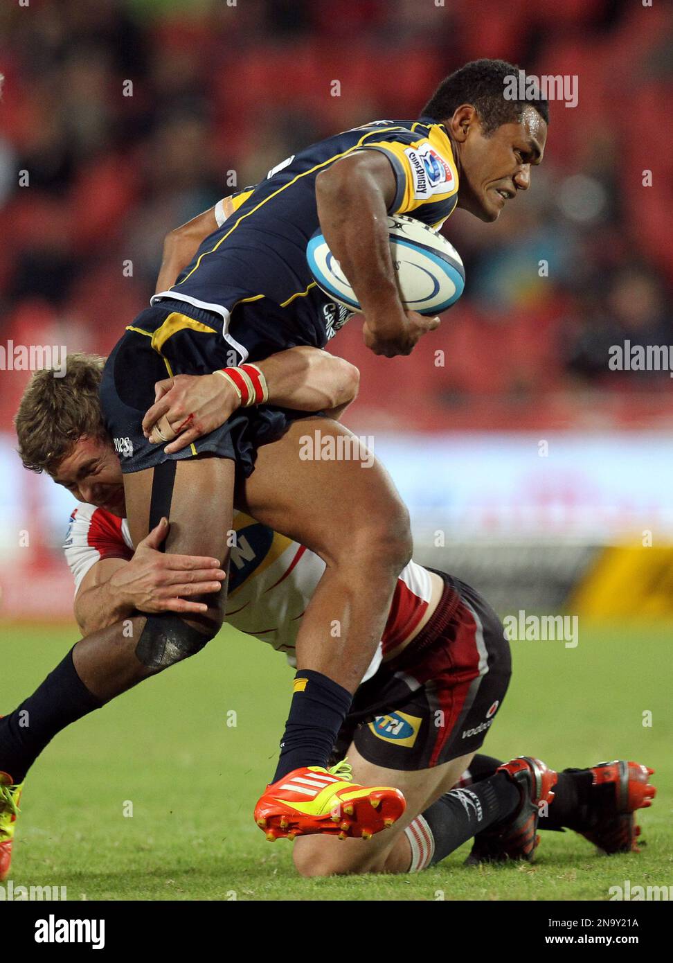 Australia's Brumbies Henry Speight, left, is tackled by South Africa's ...