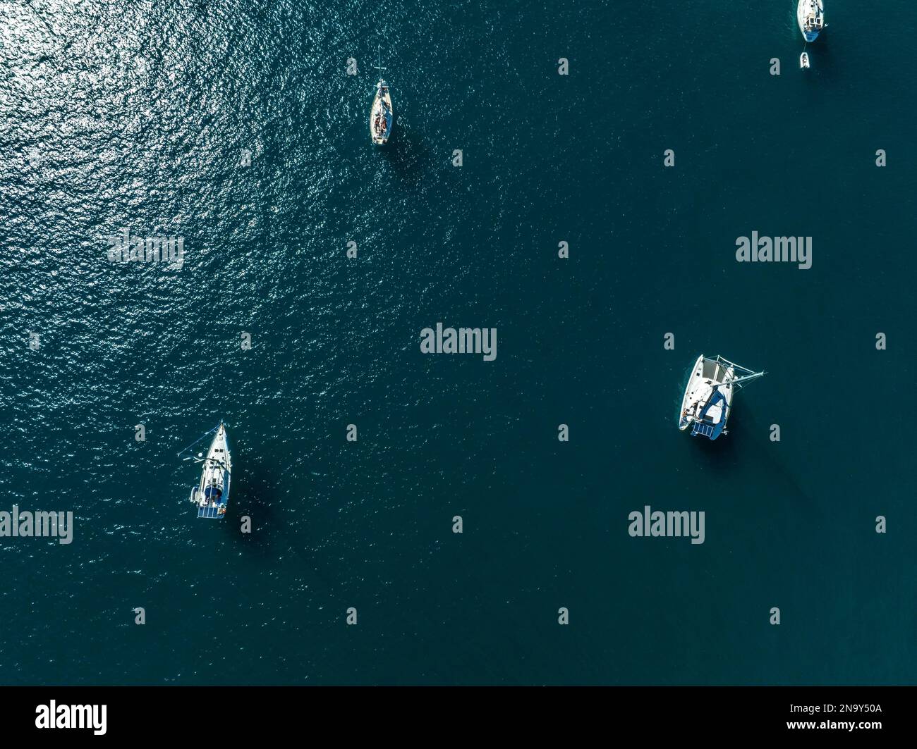 Aerial view of yacht in deep blue sea by the Gran Canaria coastline ...
