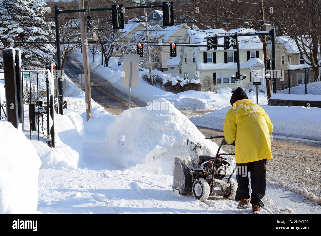 A person with a snow blower cleaning up after a record storm in the ...