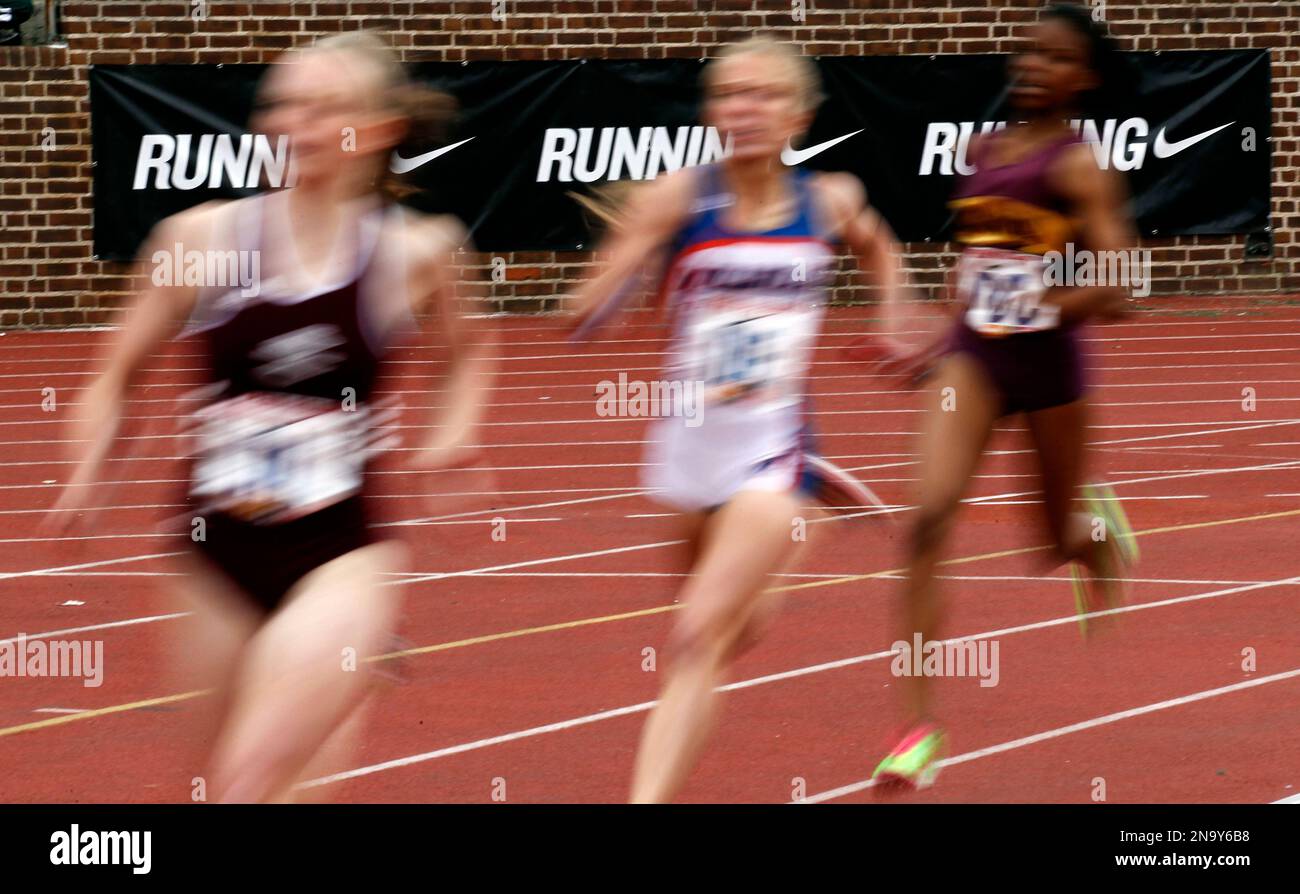 Runners take the curve in a heat of the high school girls' 1,600-meter ...