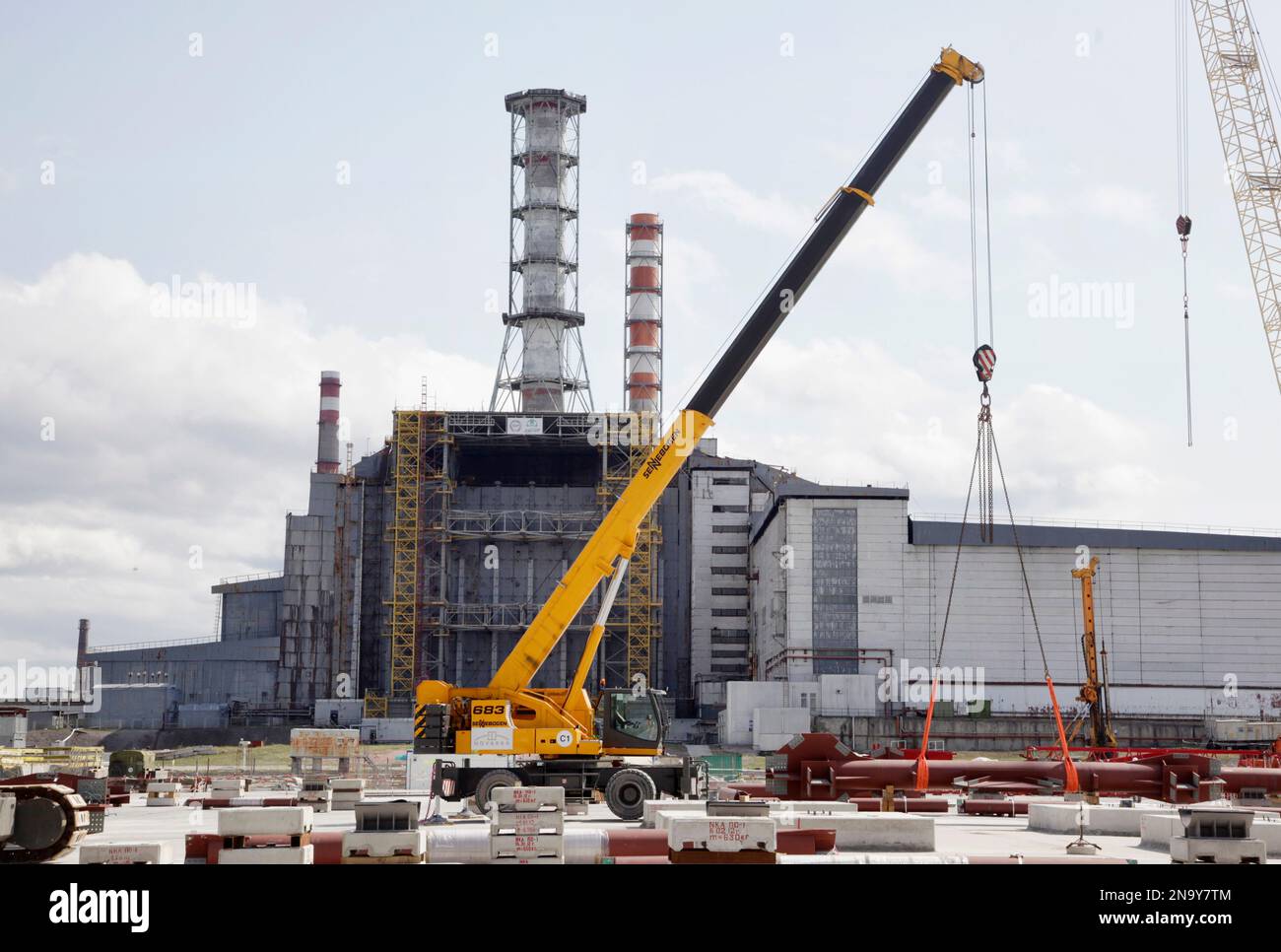 Construction workers assist in the initial assembly of a gigantic steel ...