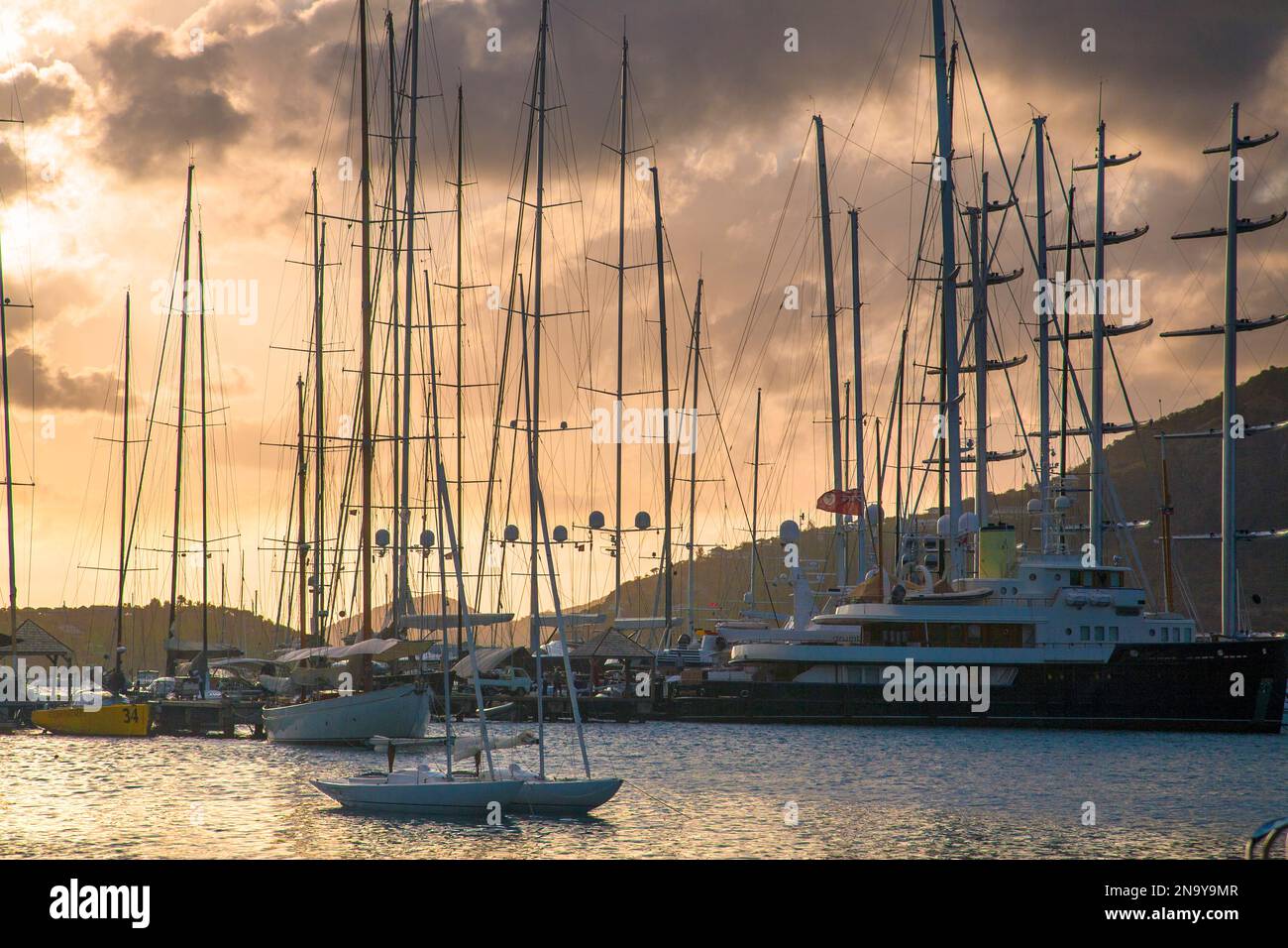 Yachts and sailboats in the harbour at sunset; Falmouth, Antigua ...