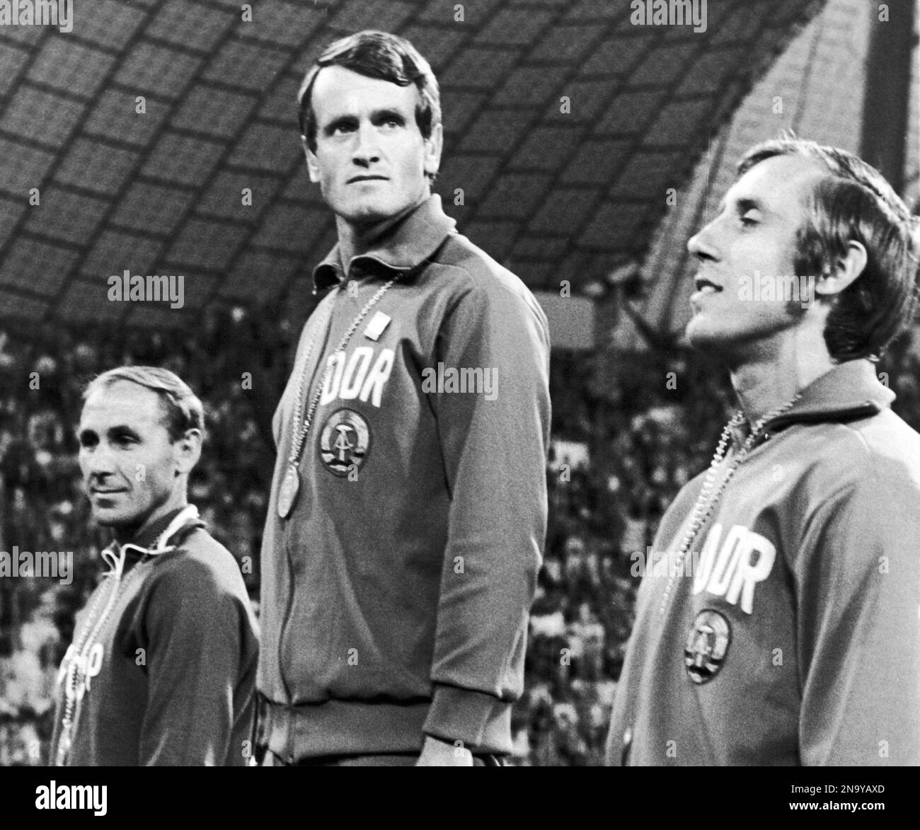 East German Peter Frenkel (gold) is flanked by fellow countryman Hans ...