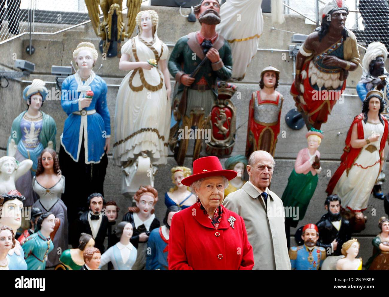 Britain's Queen Elizabeth II and Prince Philip stand with a collection ...