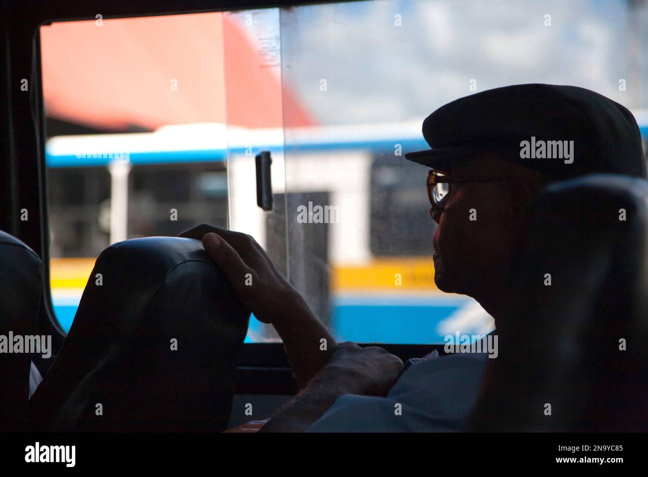 Man riding the bus and looking out the window; Bridgetown, Barbados ...