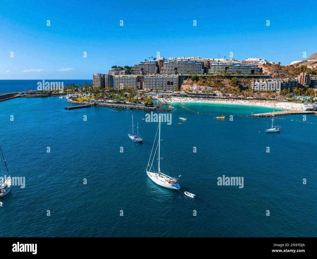 Aerial view of yacht in deep blue sea by the Gran Canaria coastline ...