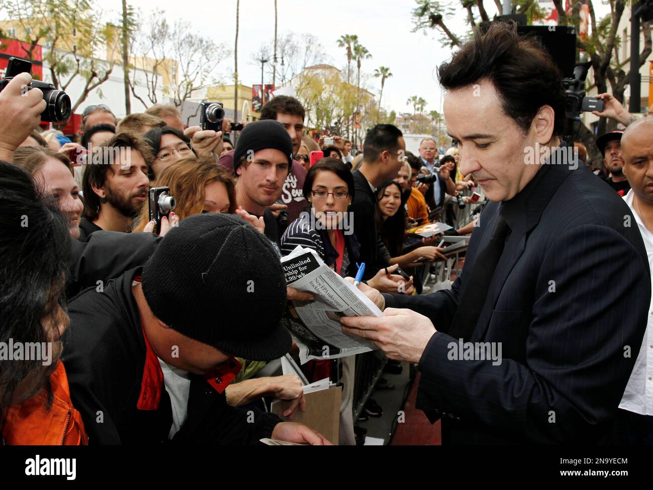 Actor John Cusack signs autographs after receiving a star on the ...