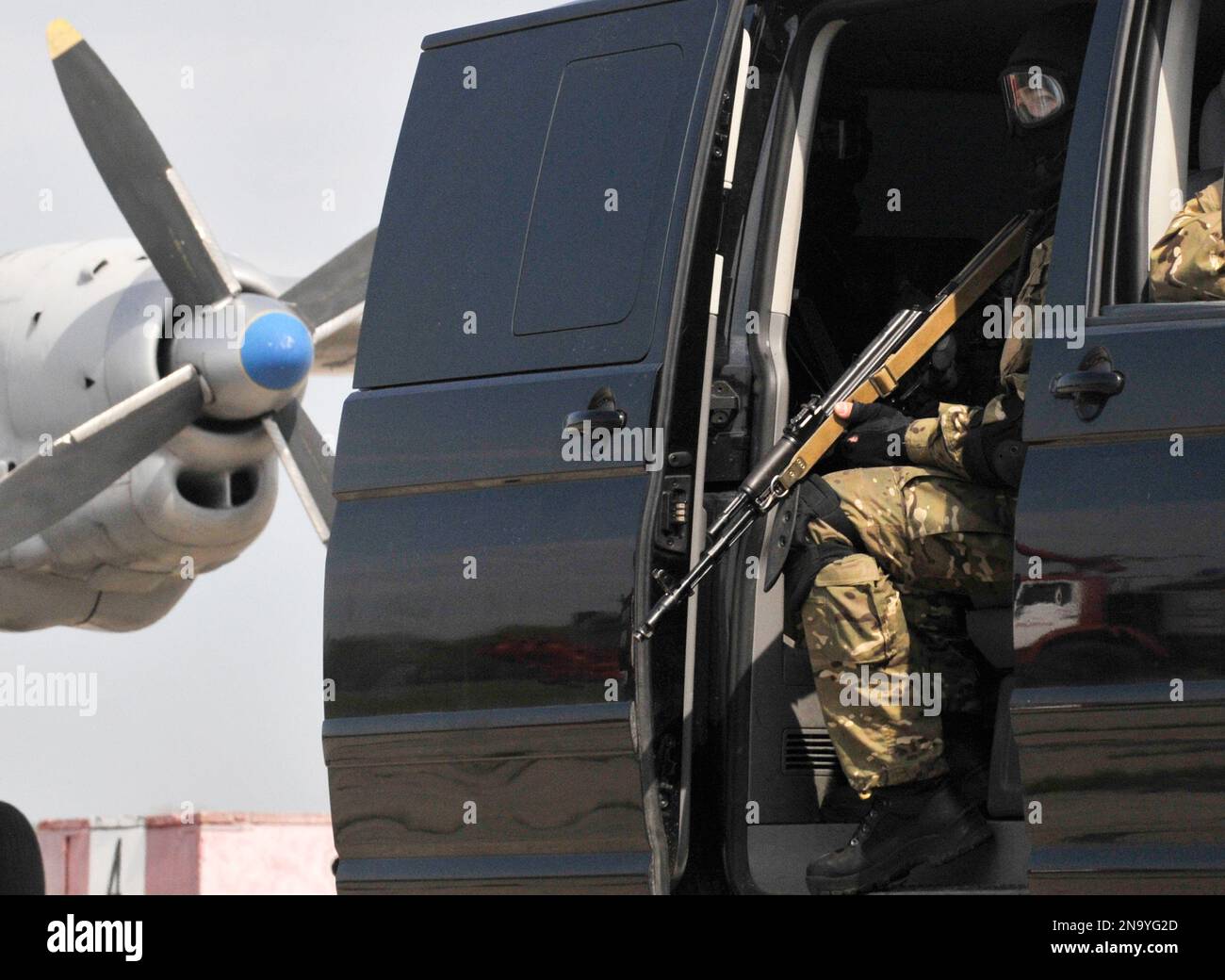 An armed agent from Ukrainian national security service waits in a van during a anti-terror ...