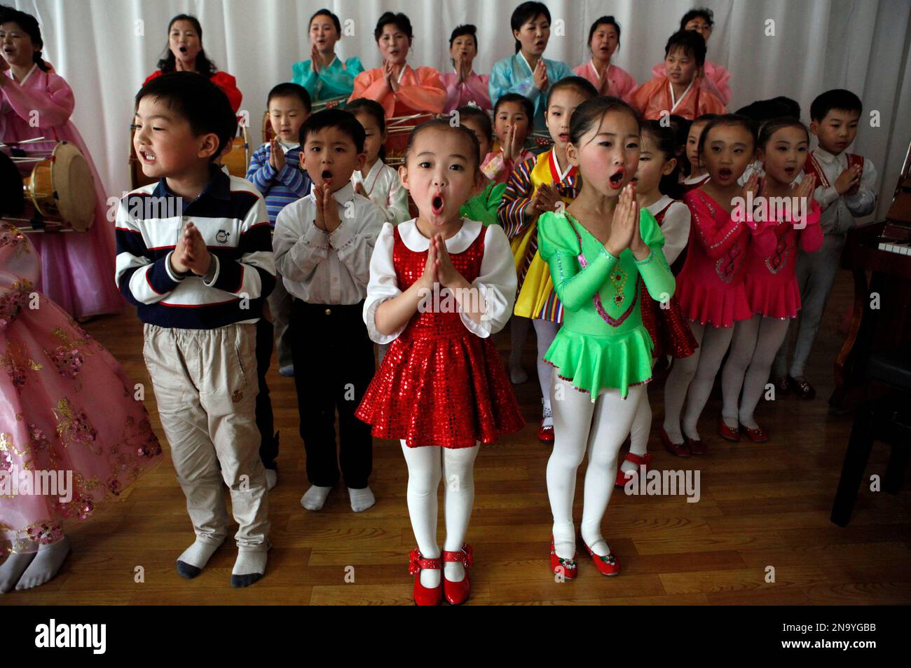 North Korean children and teachers sing for visitors at the Kaeson ...