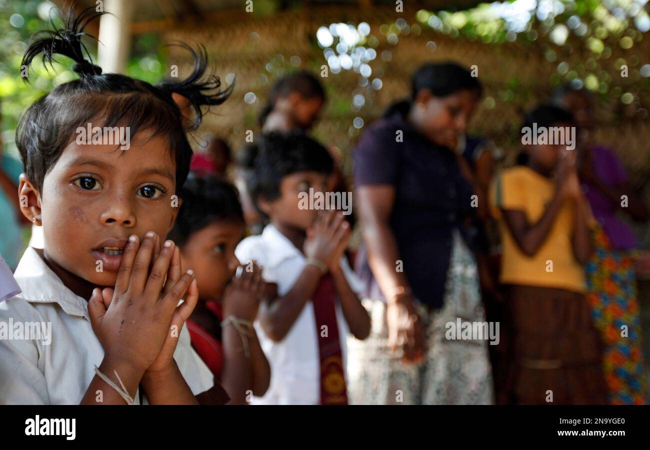 Young Hindu children pray at a temple that authorities have decided to ...