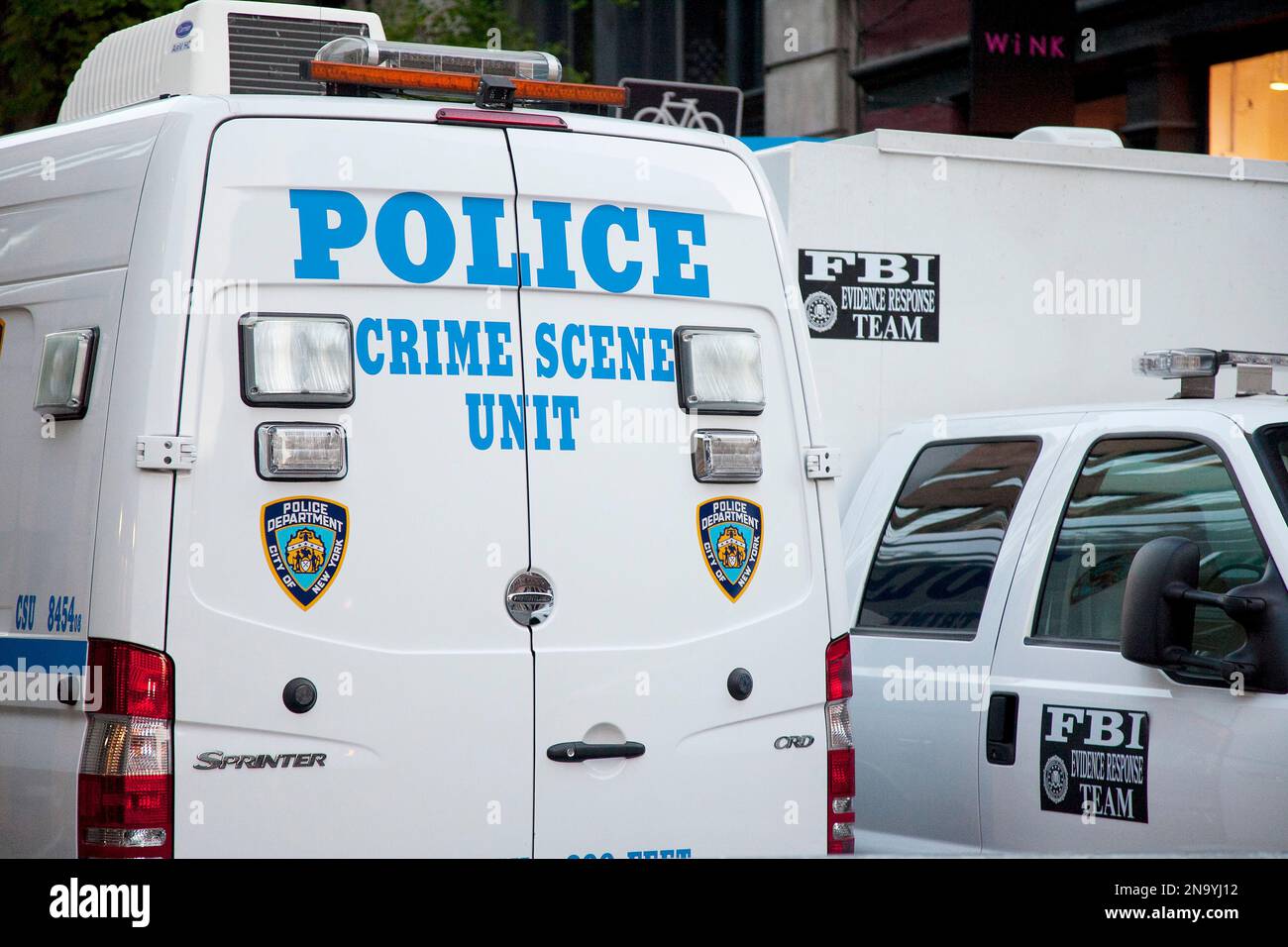 A New York Police Department Crime Scene Unit van and an FBI Evidence ...