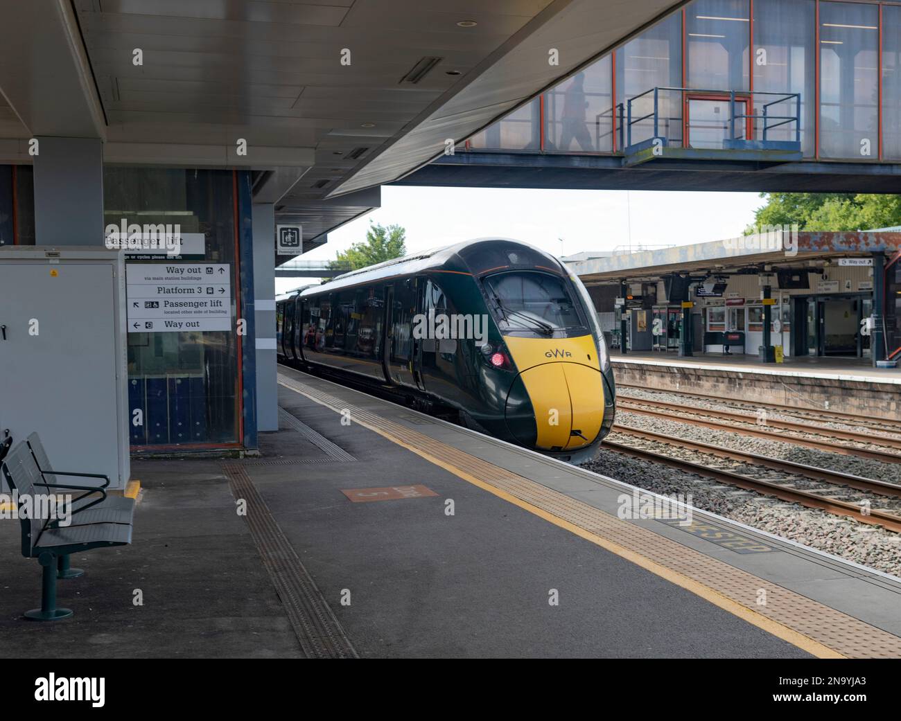 Passenger train on the tracks at a station in the UK; England Stock ...