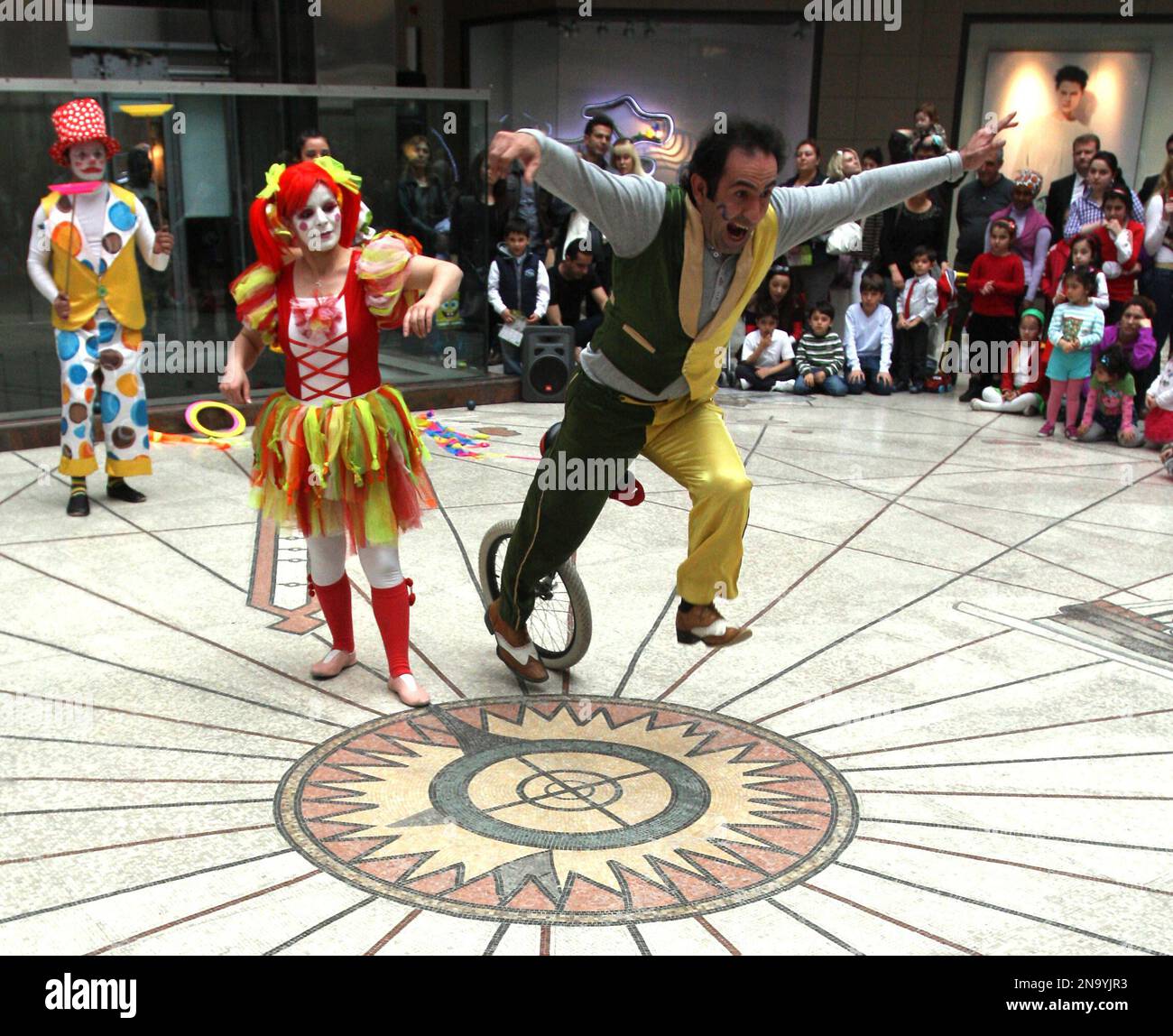 A juggler performs at a shopping mall to celebrate the National ...