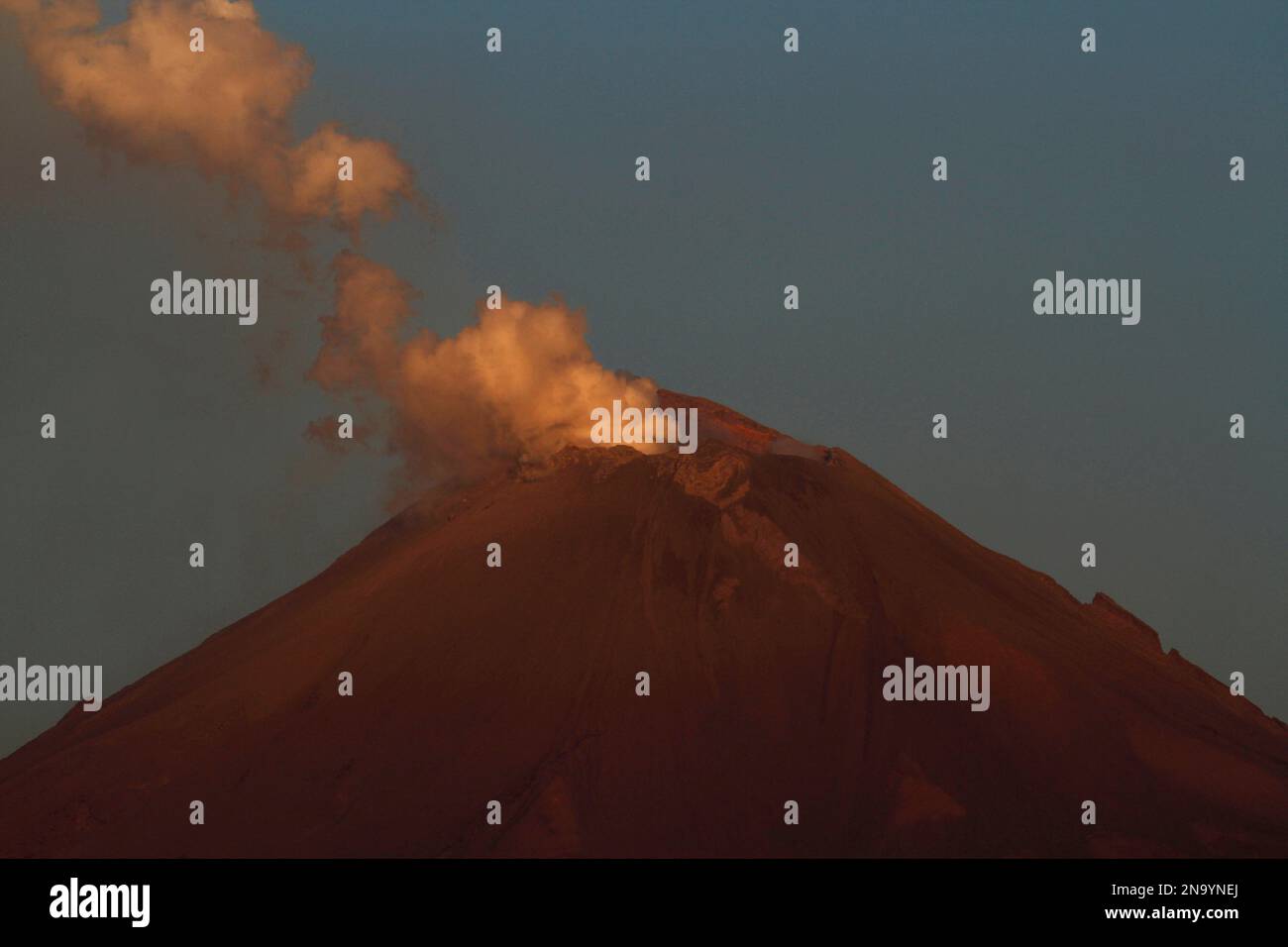 The Popocatepetl volcano releases ash and steam during an early ...