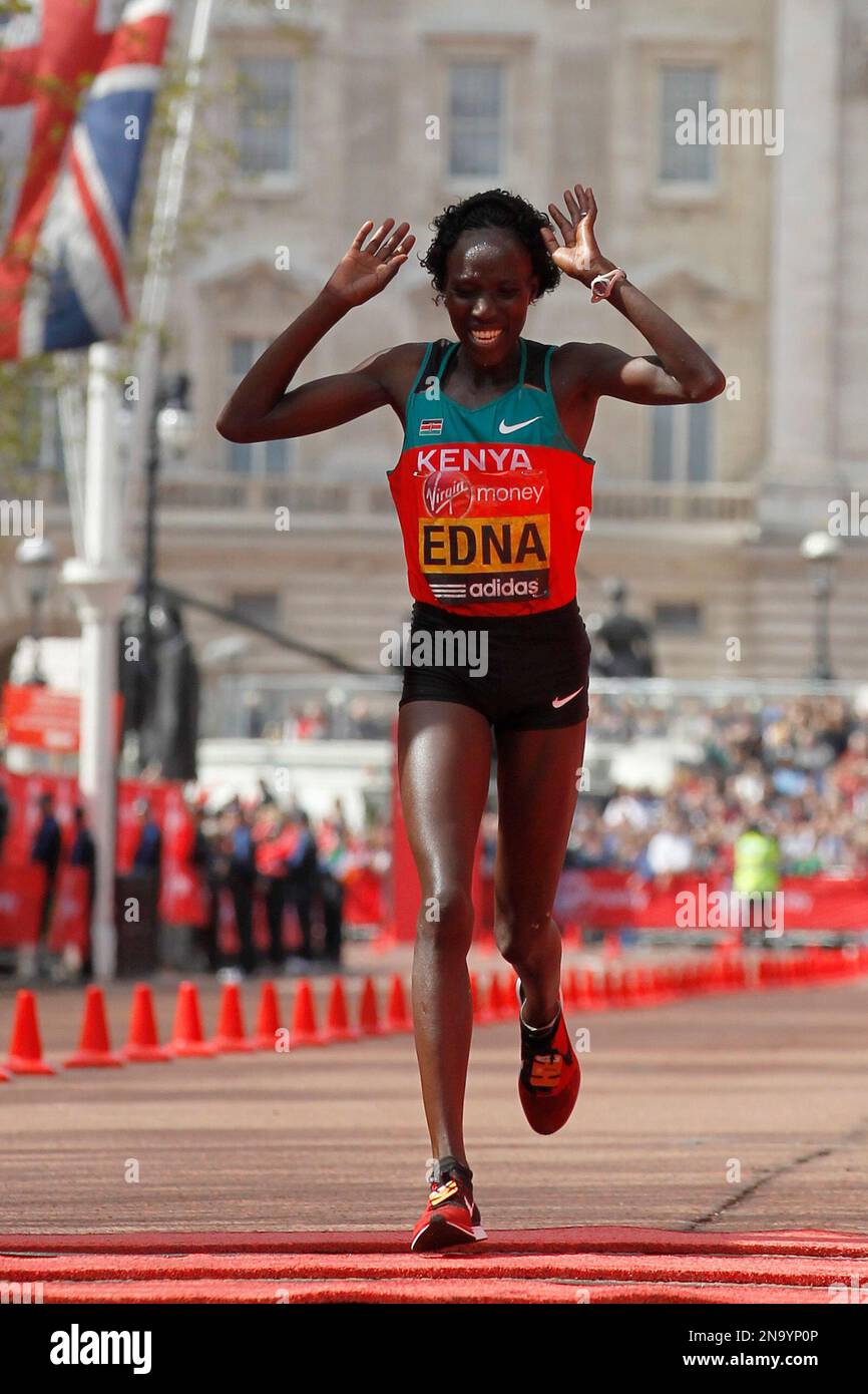 Kenya's Edna Kiplagat reacts as she crosses the finish line in second ...