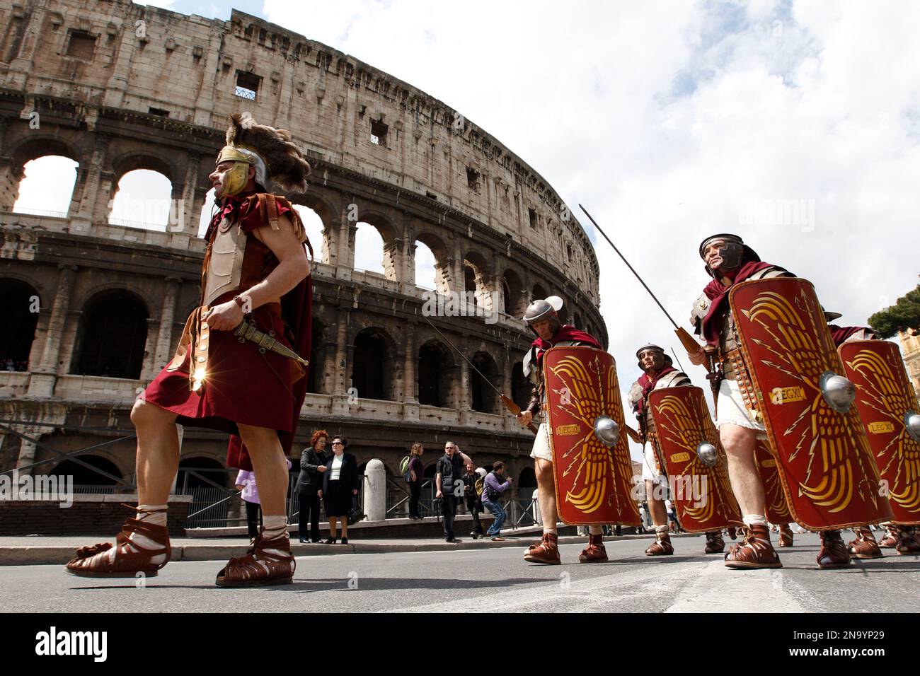 Men dressed as ancient Roman centurions parade along the Fori Imperiali ...