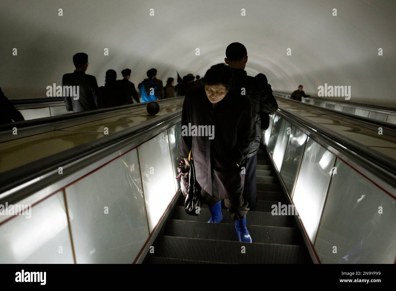 A North Korean woman takes an escalator to exit from an underground ...