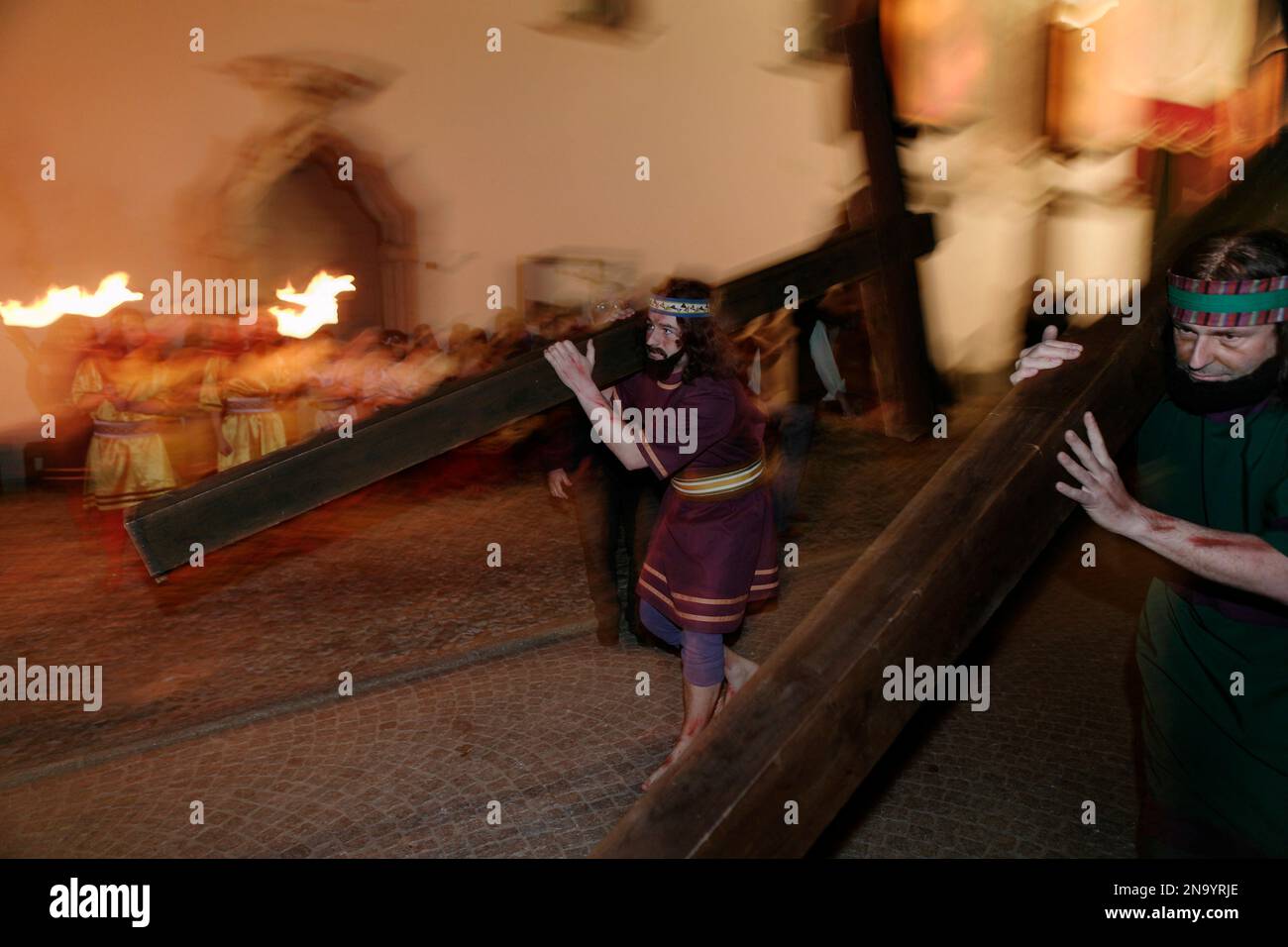 Christians dressed in costume carry crosses through the streets on Holy ...