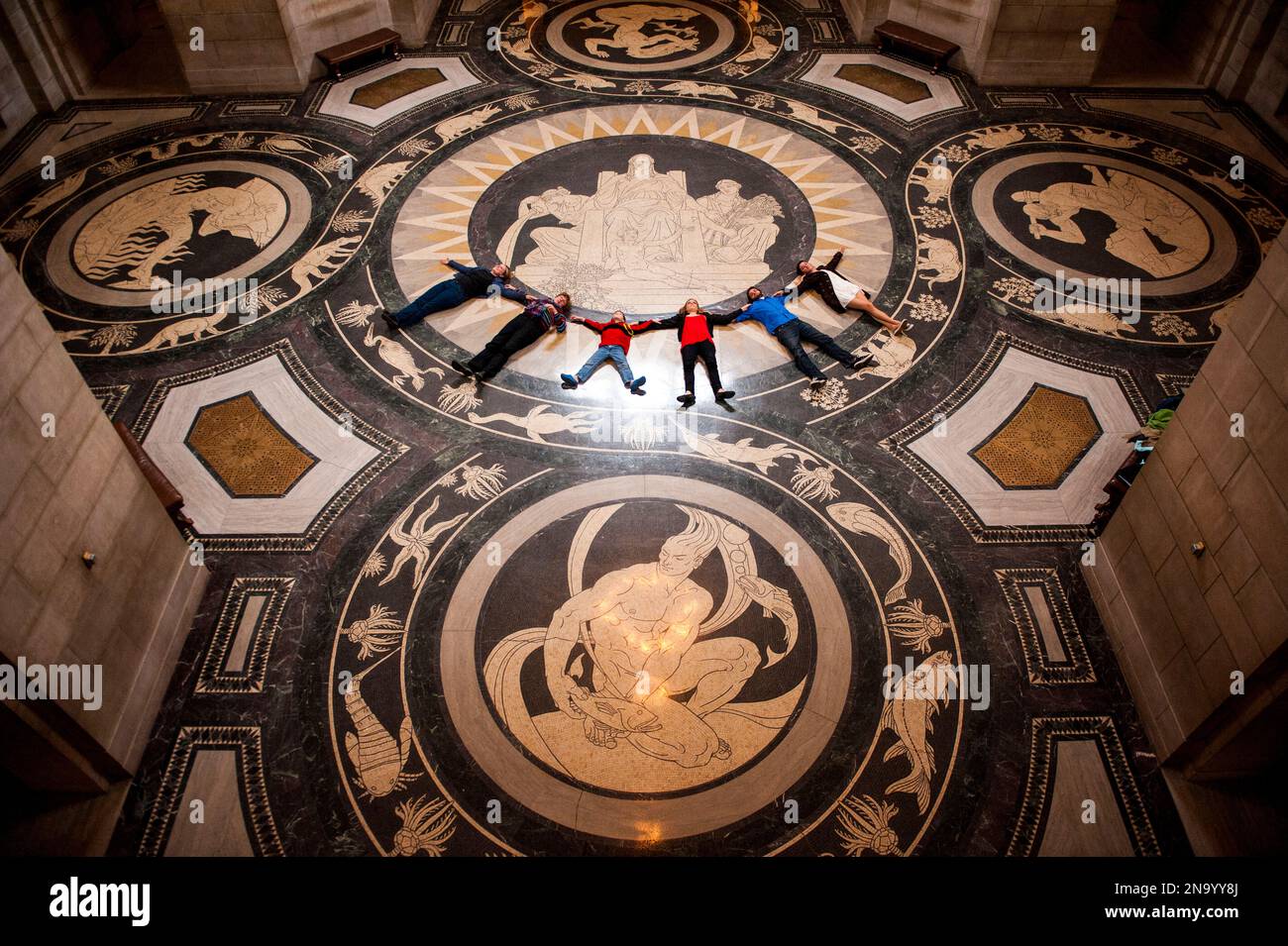 Tour group lays in a row on the decorative Rotunda floor in the ...