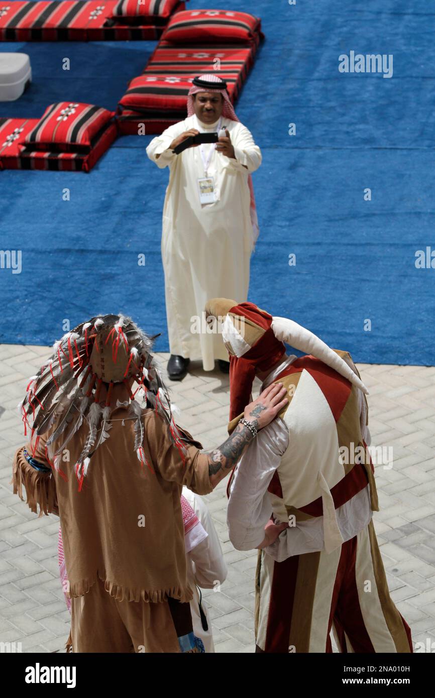 A Bahraini man dressed with traditional Arabian clothes takes picture ...