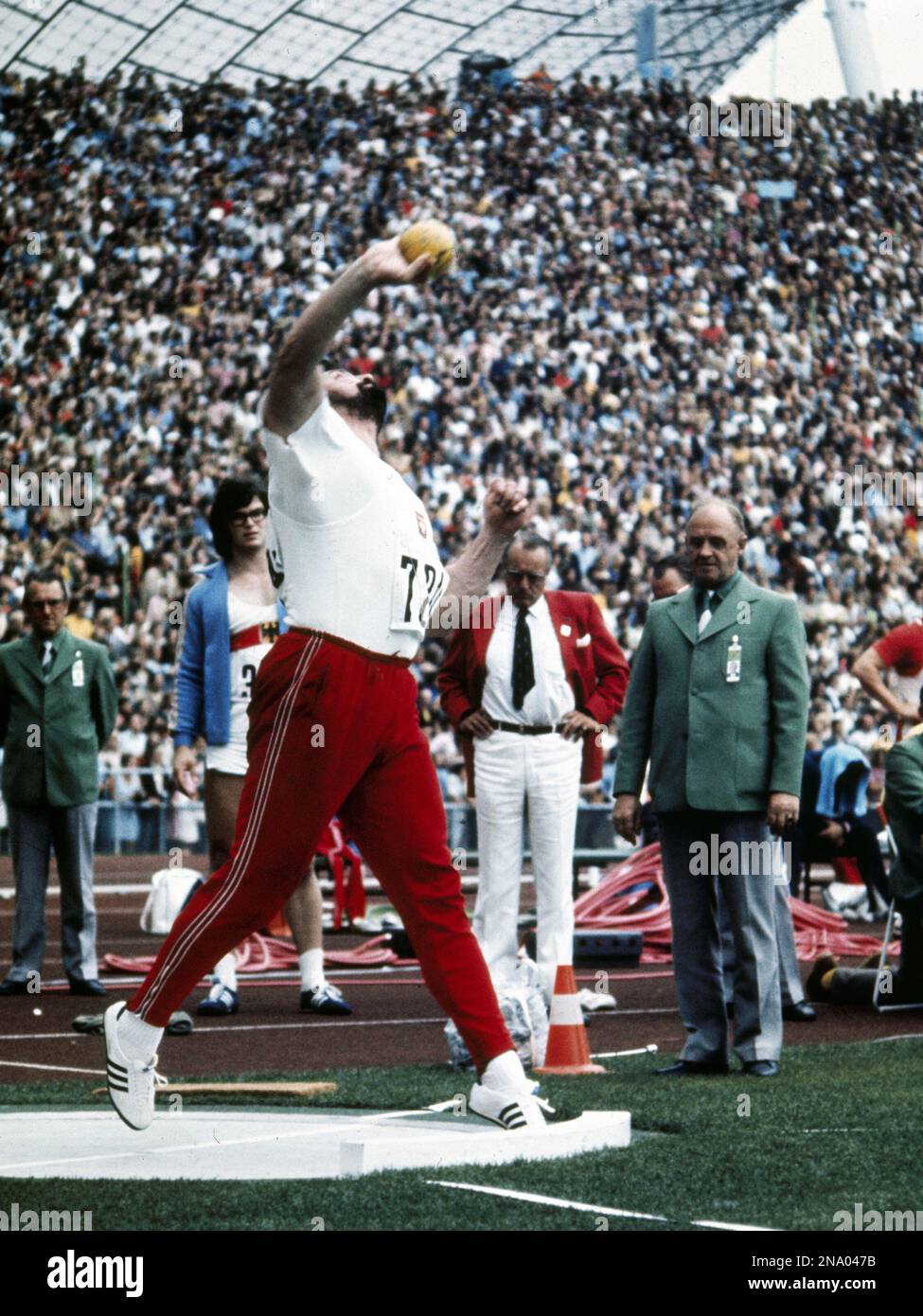 Wladyslaw Komar of Poland, puts the shot at the Summer Olympic Games ...