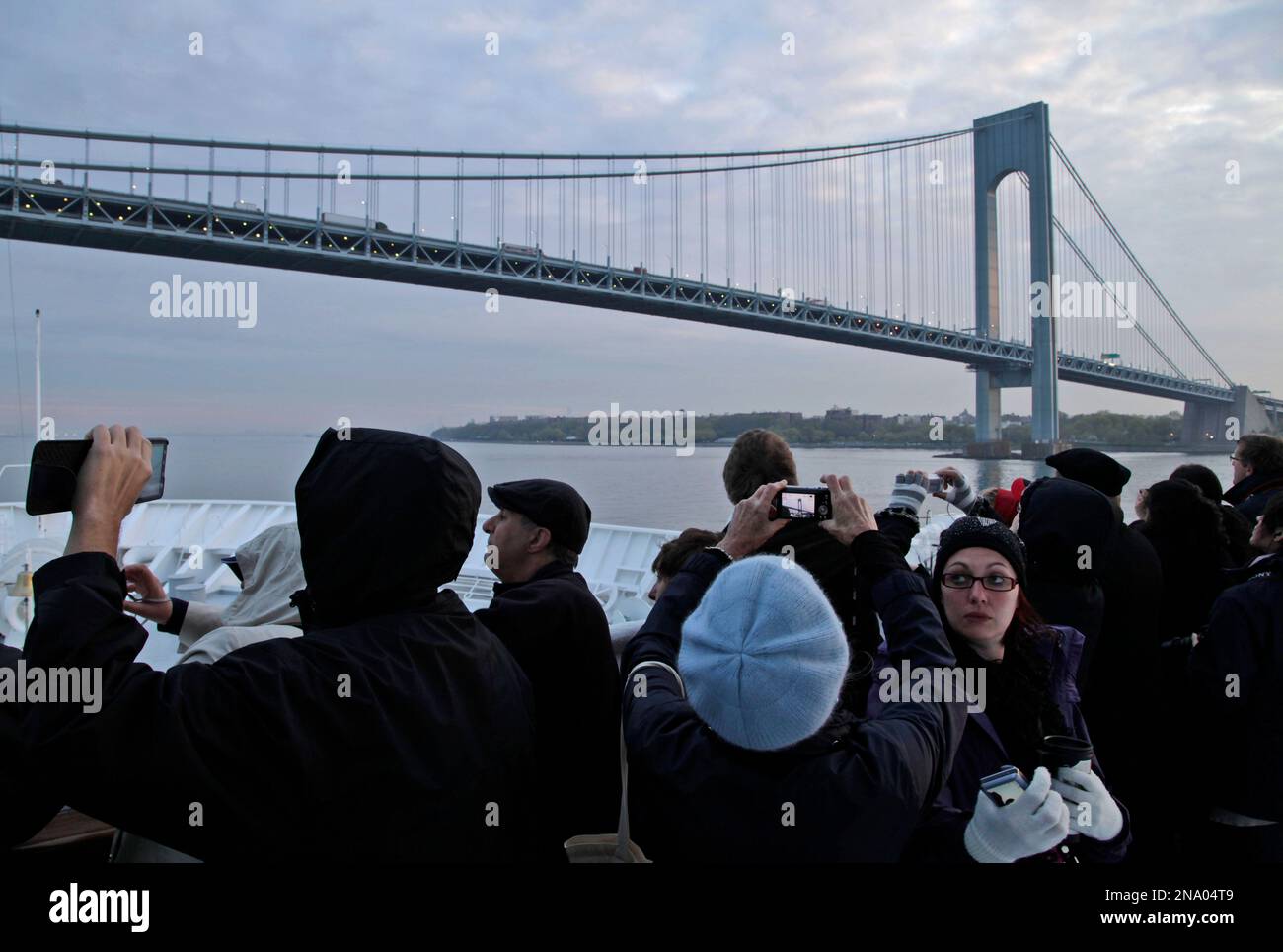 Backdropped by Verrazano-Narrows Bridge passengers watch as the MS ...