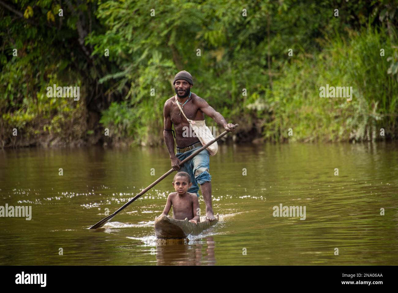 Father and son on the Karawari River, located in the Sepik area of ...