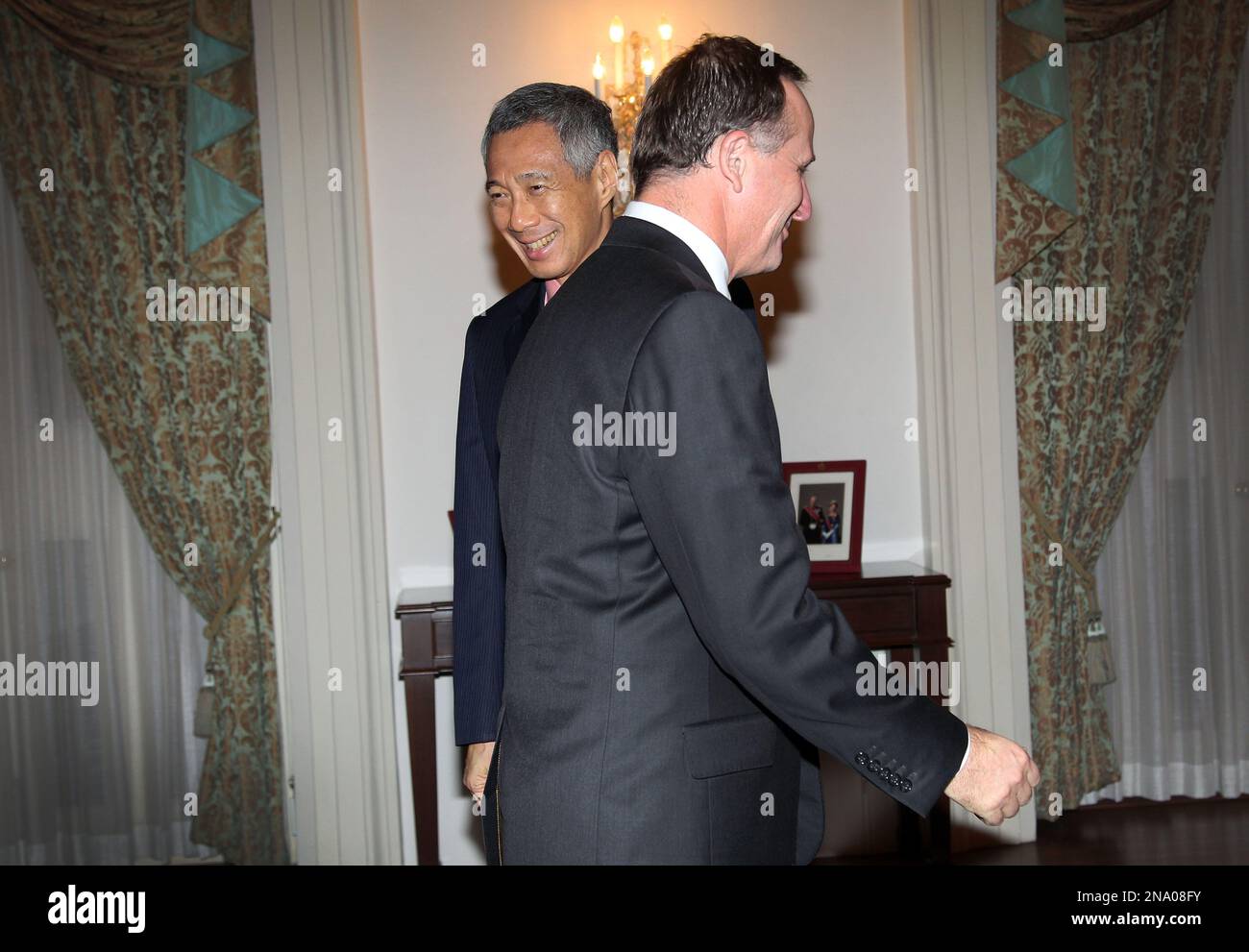 New Zealand's Prime Minister John Key, right, walks by Singapore's ...