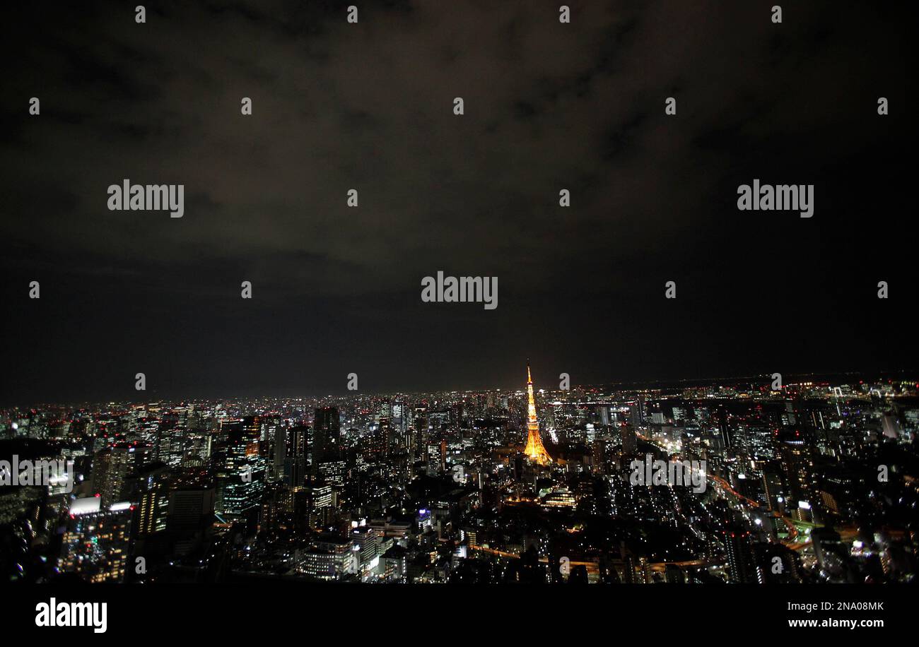 Tokyo Tower stands illuminated among buildings in Tokyo Wednesday ...
