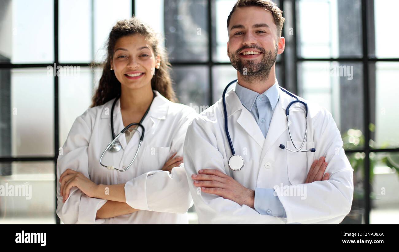 a female doctor and a male doctor are standing in the office with their ...