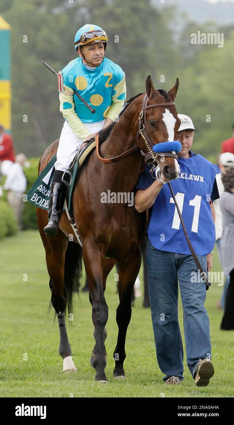 Bodemeister and jockey Mike Smith (11) are led around the infield ...