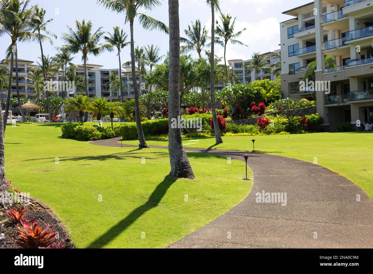 Pathway winding through lush tropical gardens on a Hawaiian resort ...