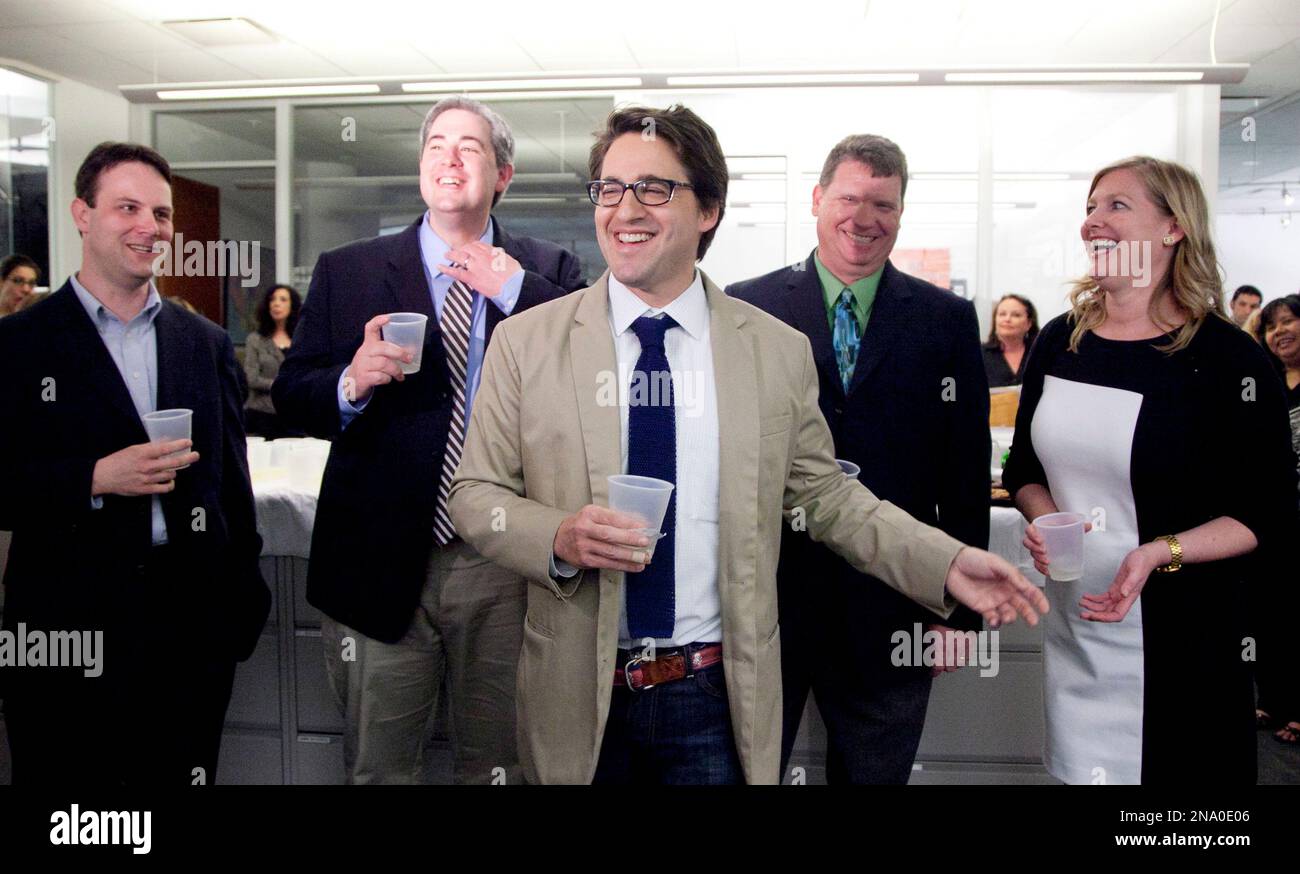 Associated Press reporter Adam Goldman, center, smiles as he and former ...