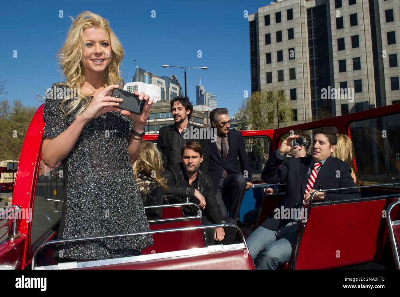 U.S actress, Tanya Reid takes a photo of Tower Bridge, for an American ...