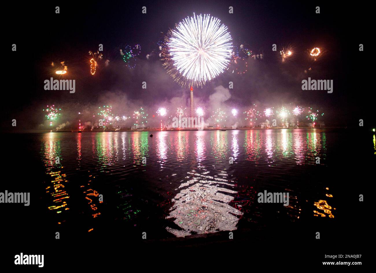 Fireworks are reflected in the Taedong River in Pyongyang as they ...