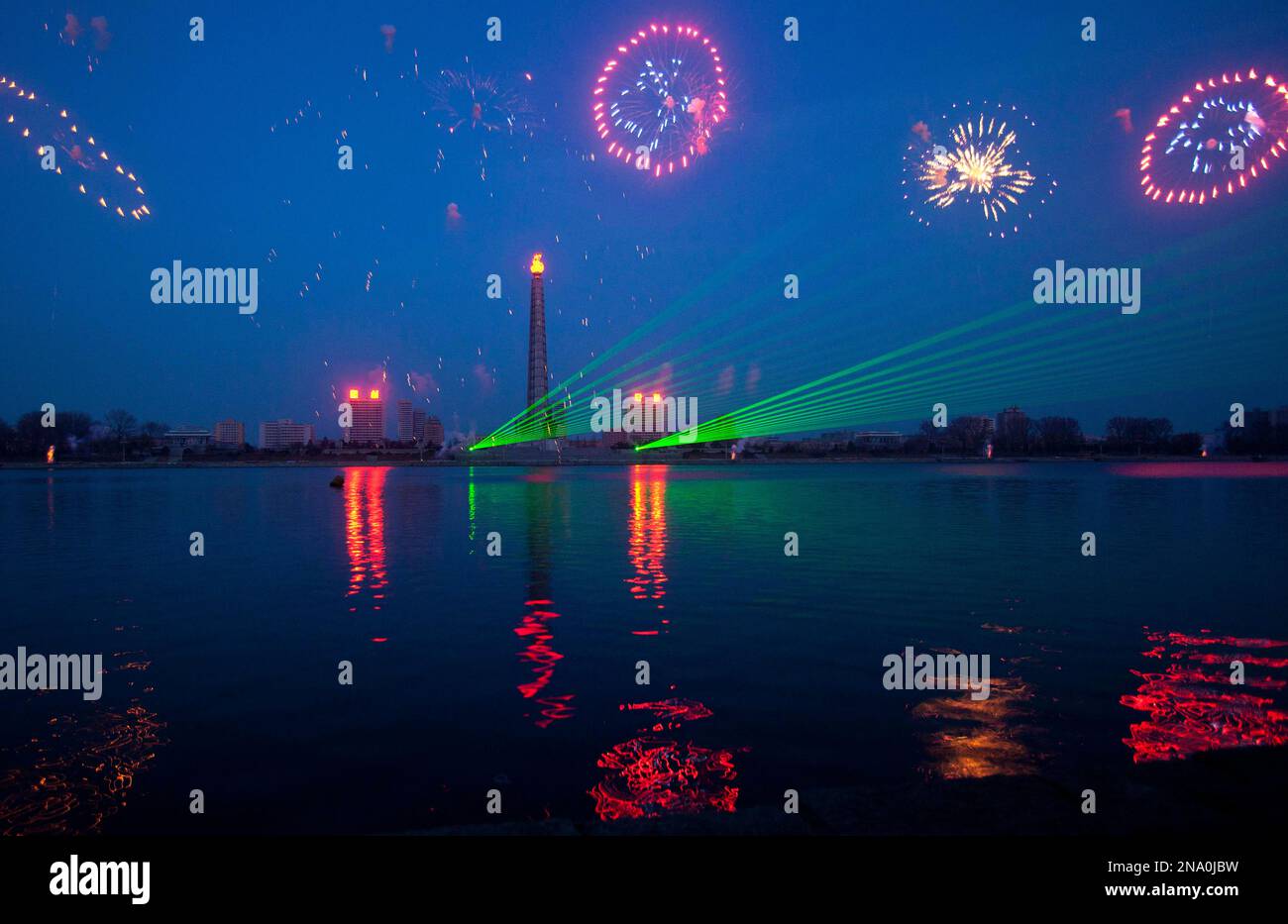 Fireworks are reflected in the Taedong River in Pyongyang as they ...