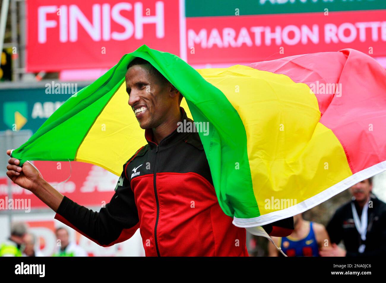 Ethiopian runner Yemane Adhane draped in the Ethiopian flag after ...