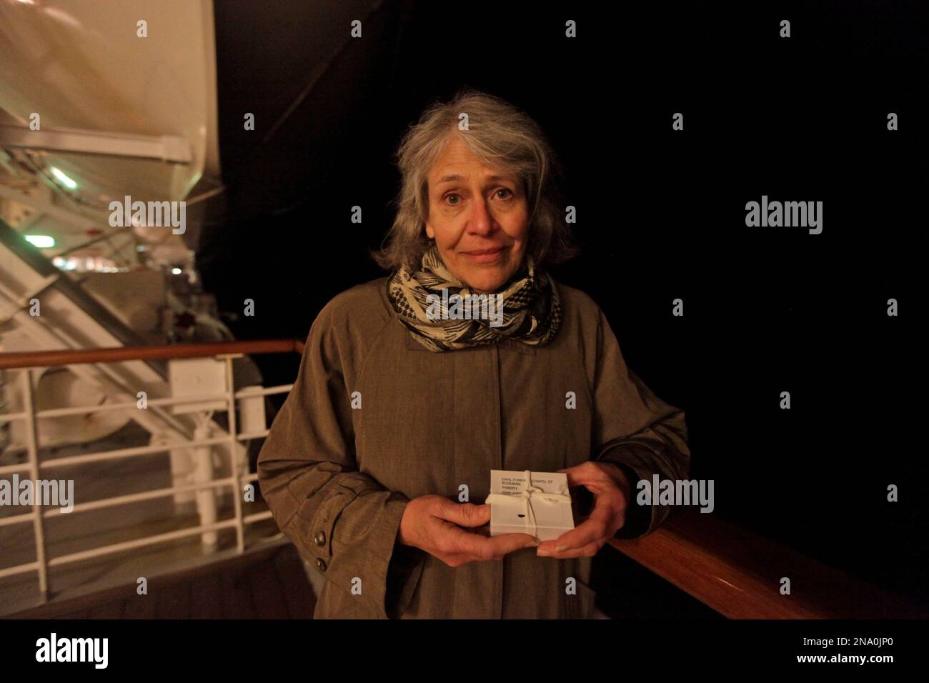 Helen Edwards, 62, from Silver Spring, Maryland holds a box with ashes ...